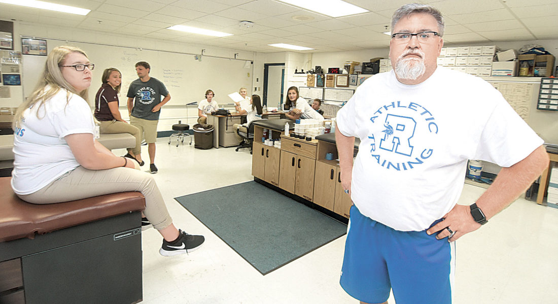 Ripley High School athletic director and trainer works with student ...